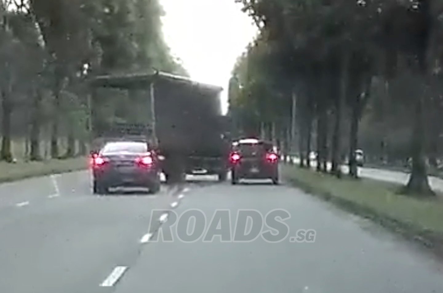 Car cuts dangerously in front of truck causing truck to skid