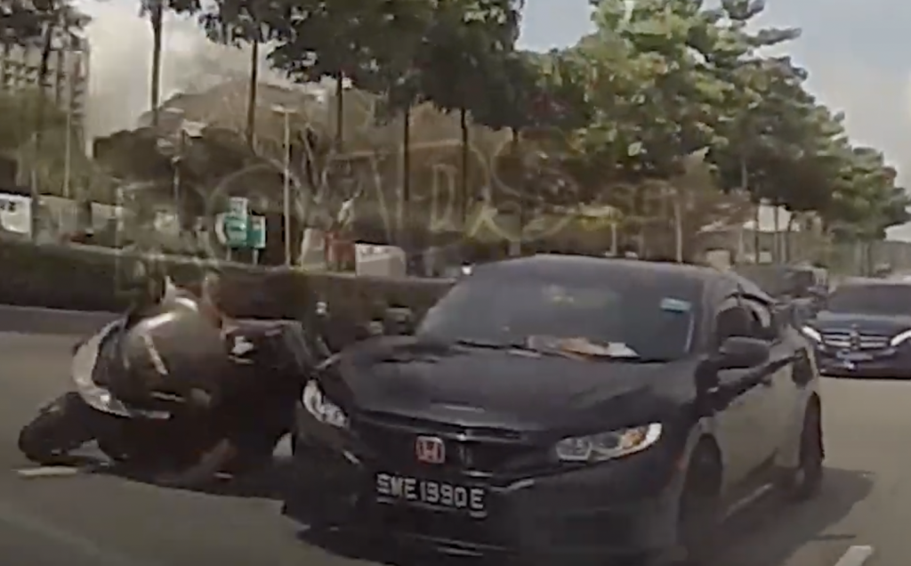 Reckless driver hits a motorcyclist when lane changing